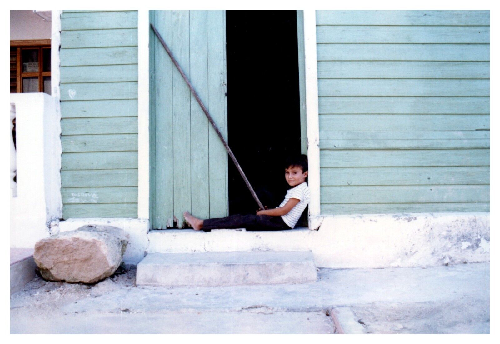 1990s Mexican Boy In Front of Door Vintage Photo – techrewinds